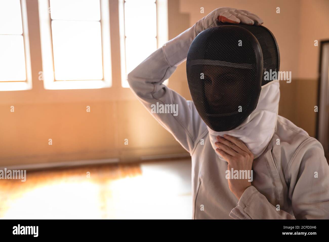 Woman wearing fencing outfit Stock Photo - Alamy