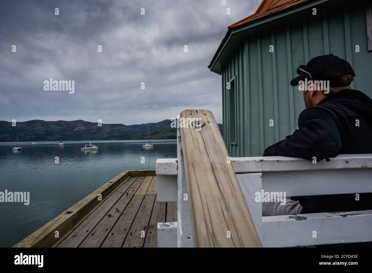 Tourist on the jetty in Akaroa harbor Stock Photo - Alamy