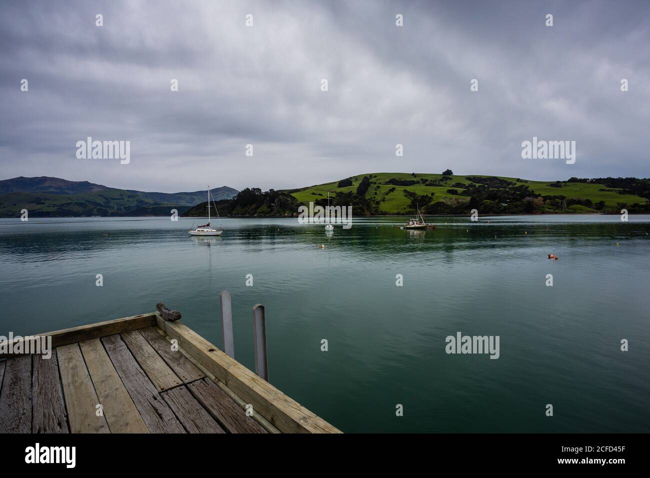 Jetty in Akaroa harbor Stock Photo - Alamy
