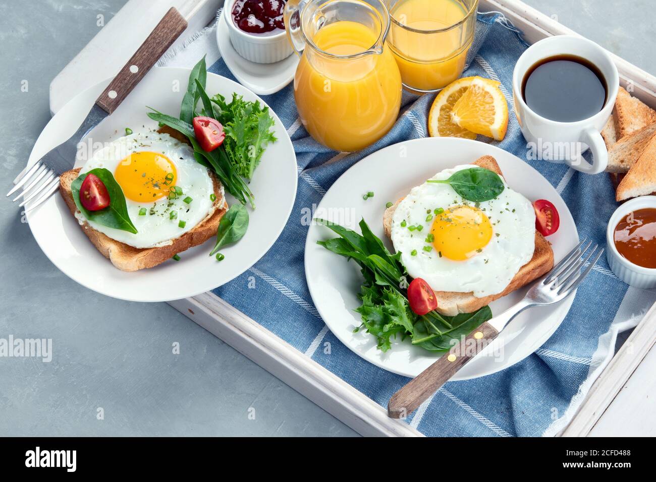 Traditional breakfast served in white wooden tray on grey background ...