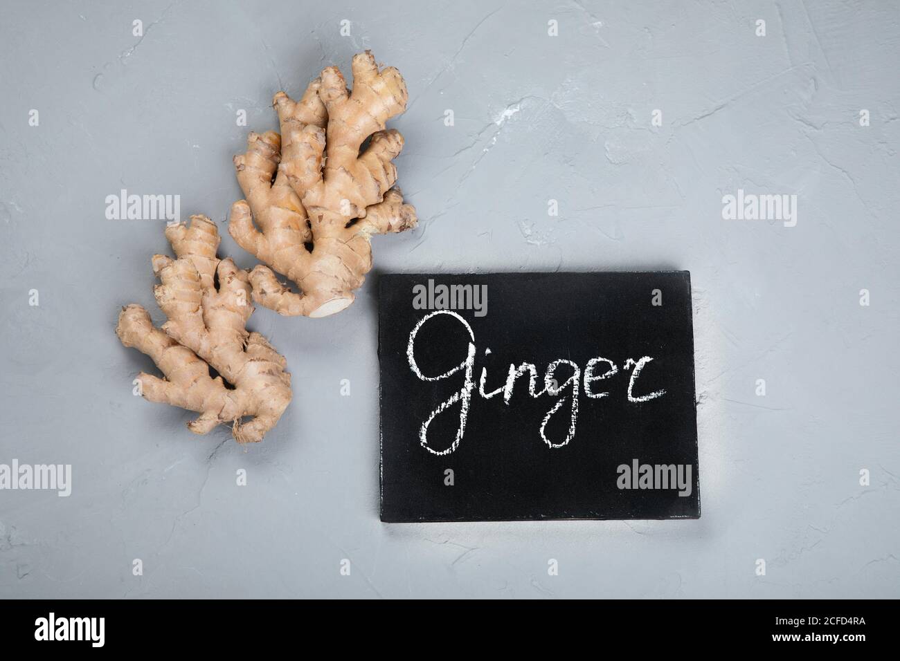 Fresh ginger root and ginger powder. Top view, chalkboard Stock Photo ...