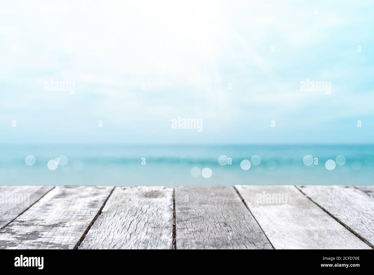 Selective focus of old wood table with blur beautiful beach background ...
