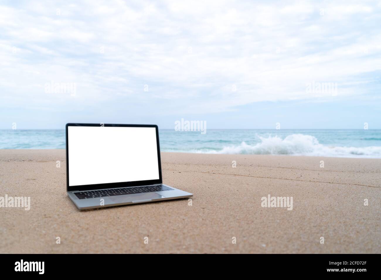 Laptop on sand at summer beach in background with white screen Stock ...