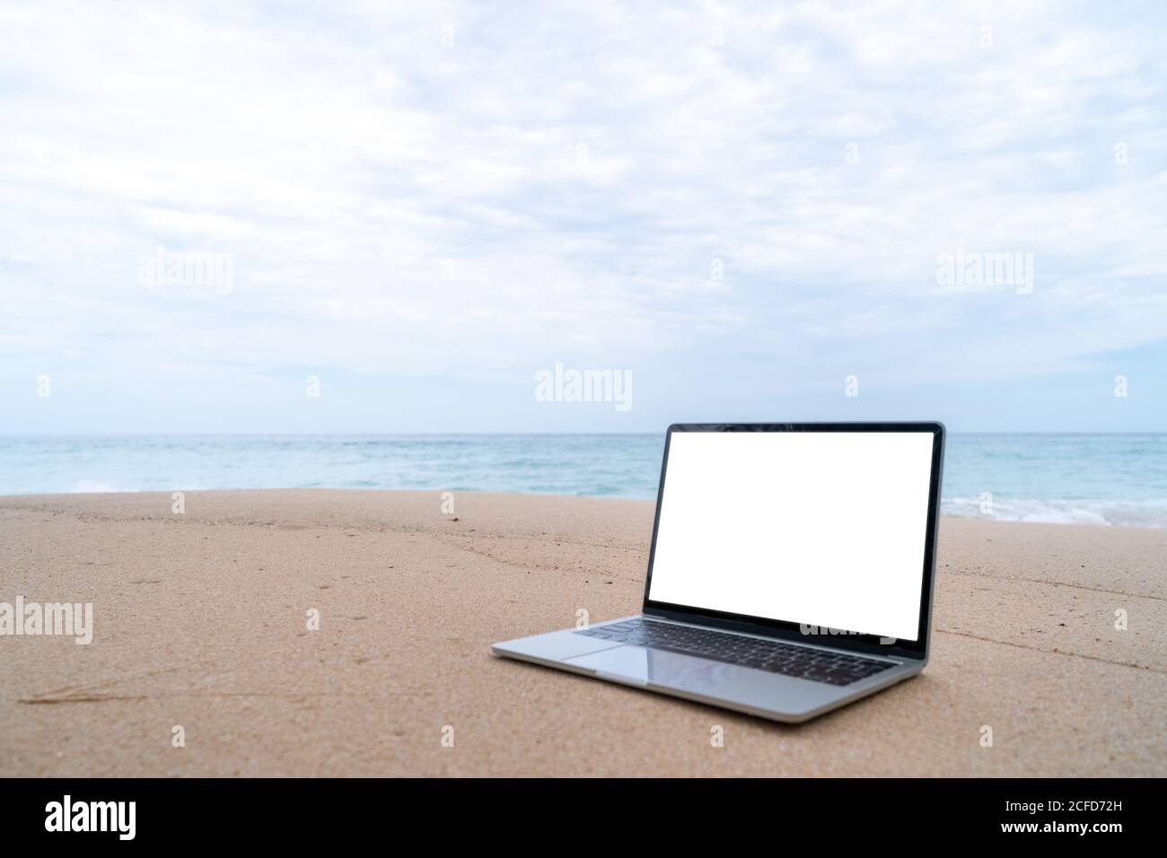 Laptop on sand at summer beach in background with white screen Stock ...