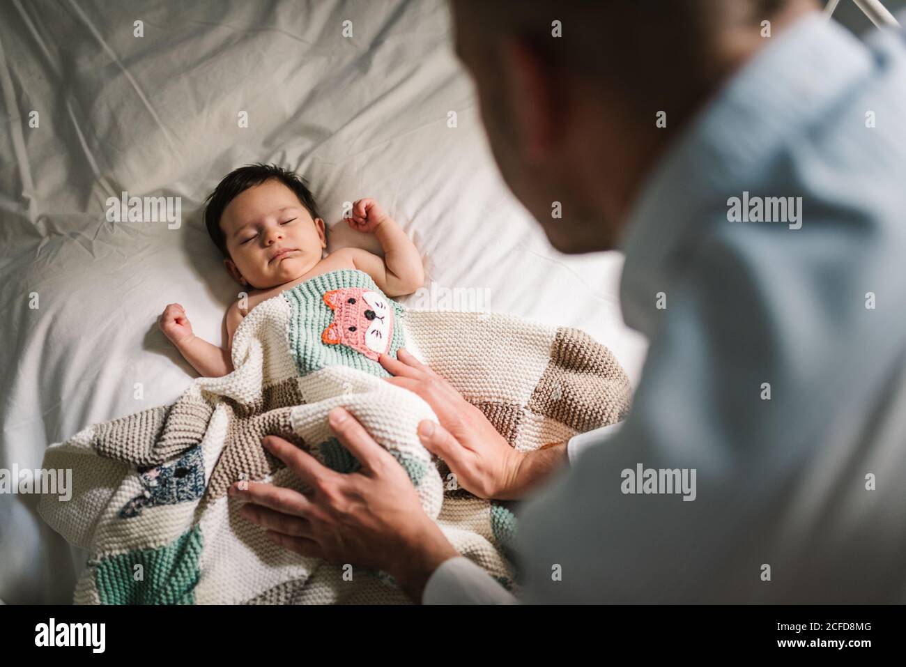 anonymous father wishing good night to baby Stock Photo - Alamy