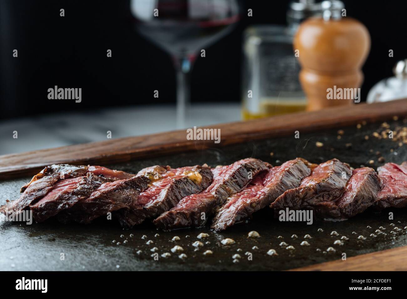 Top view of medium rare slices steak on table with fork and knife in ...