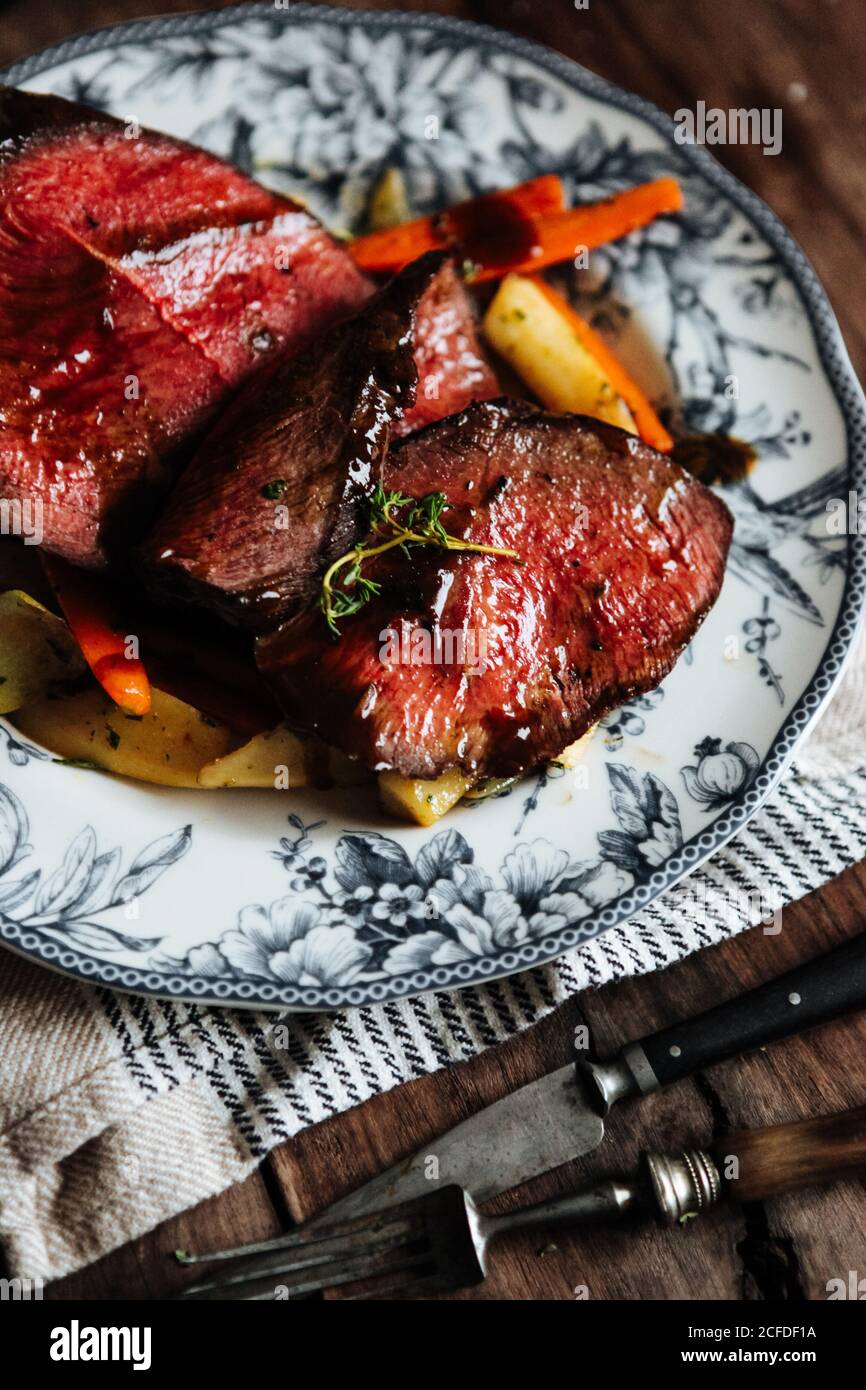 Juicy roast beef on vegetables hi-res stock photography and images - Alamy
