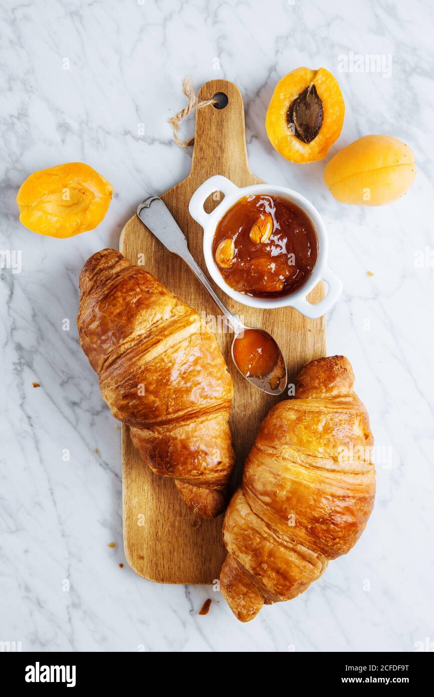 Top view of appetizing fresh croissant served with pot of homemade ...