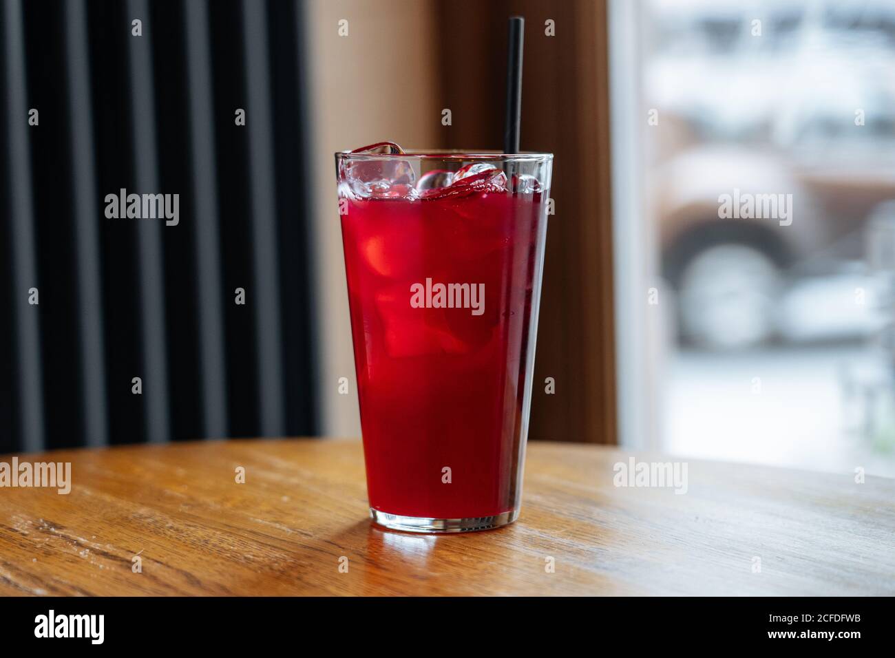 Tasty cold red cocktail on table Stock Photo - Alamy