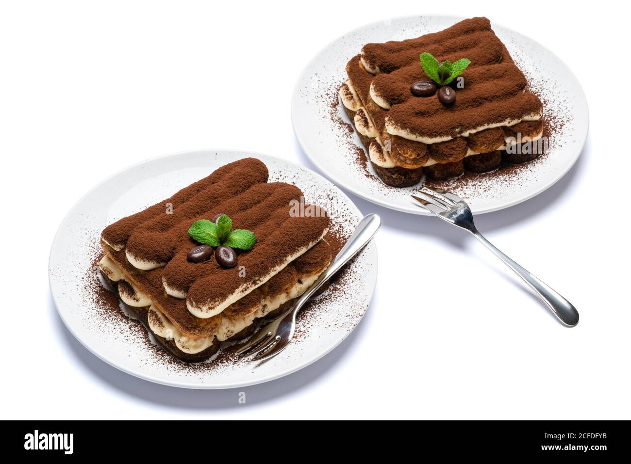 Two portions of Classic tiramisu dessert on ceramic plate isolated on ...