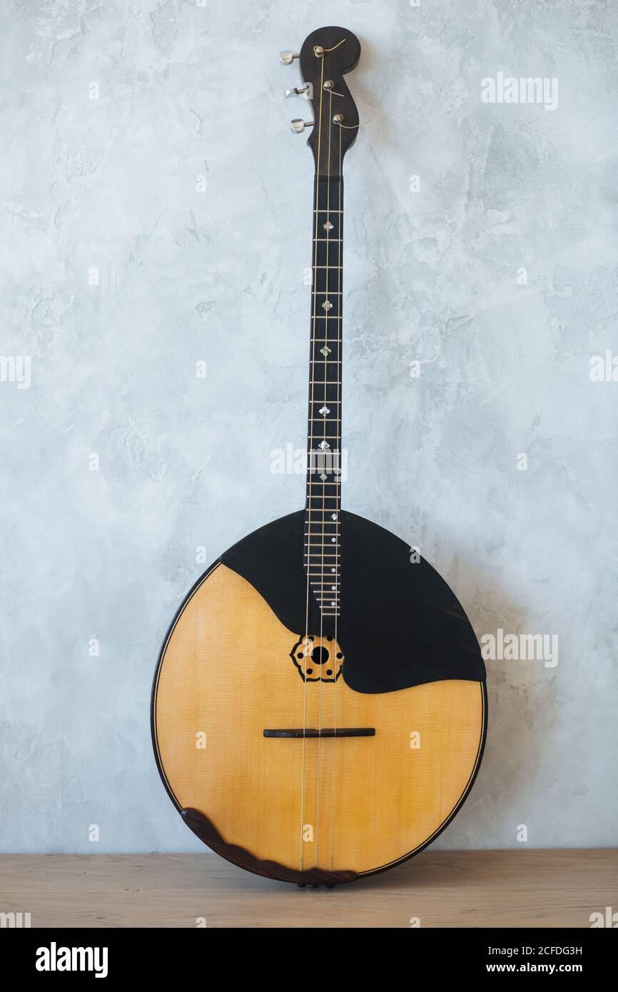 Classic wooden banjo against wall Stock Photo - Alamy