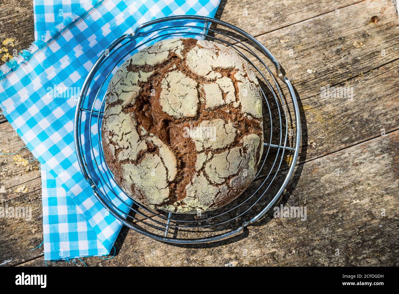 Round, freshly baked loaf of bread from above, weathered wood ...
