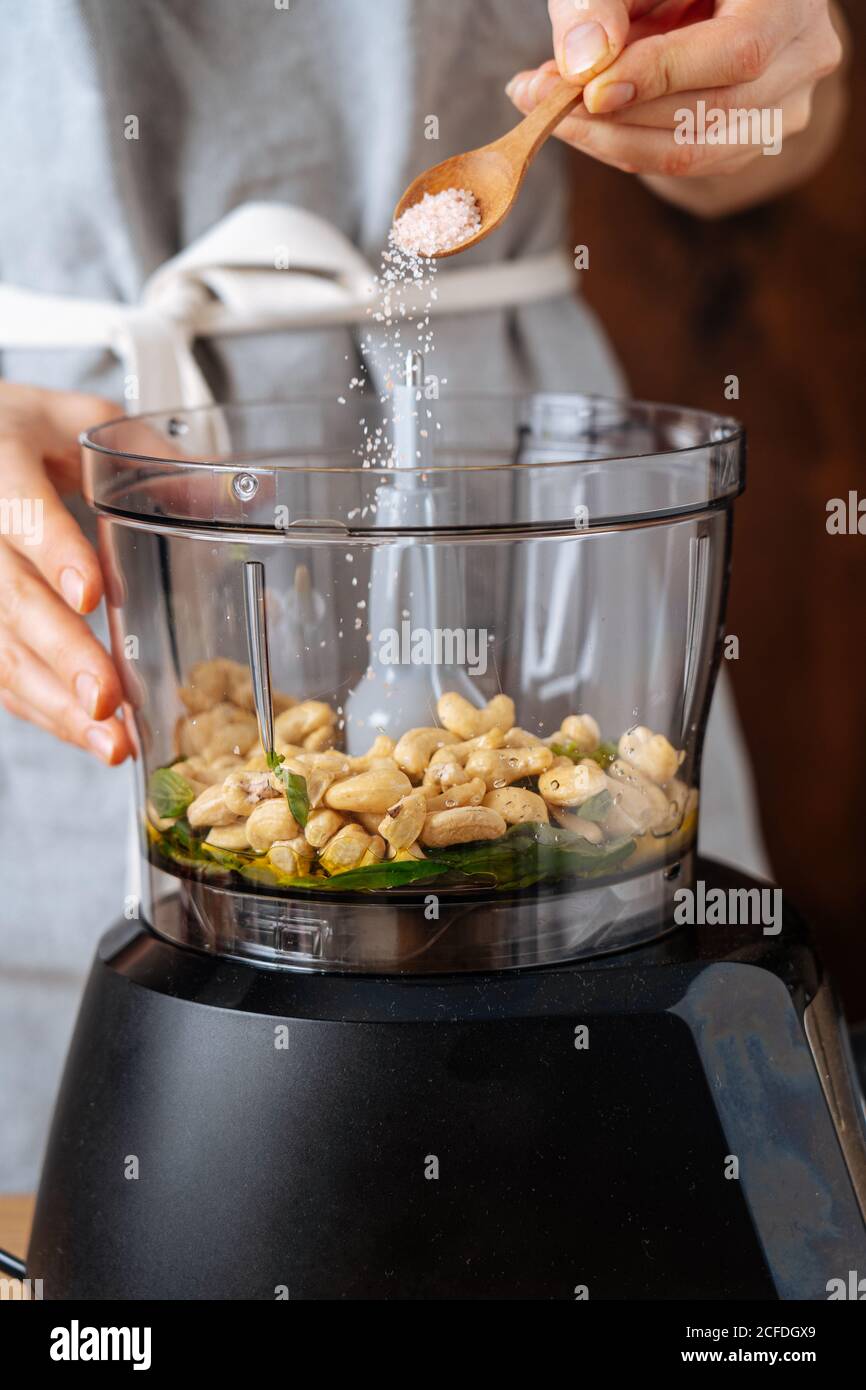 Woman adding salt to food hi-res stock photography and images - Alamy