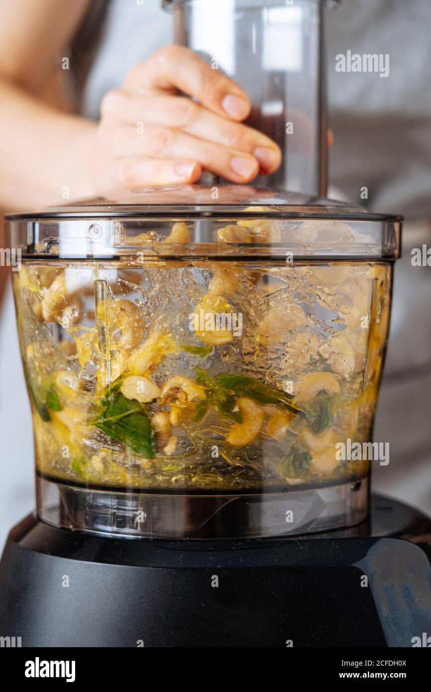 anonymous person mixing ingredients in blender Stock Photo - Alamy