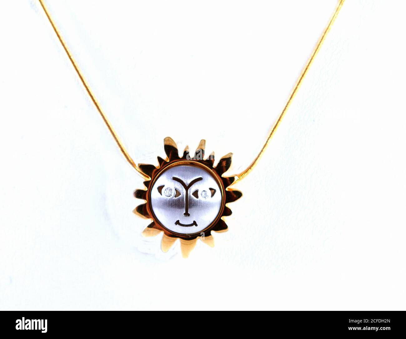 Golden sun with a white face and diamonds in the eyes Stock Photo - Alamy