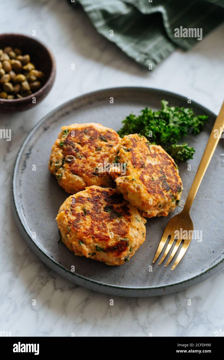 Grilled fish cutlets on metal plate Stock Photo - Alamy