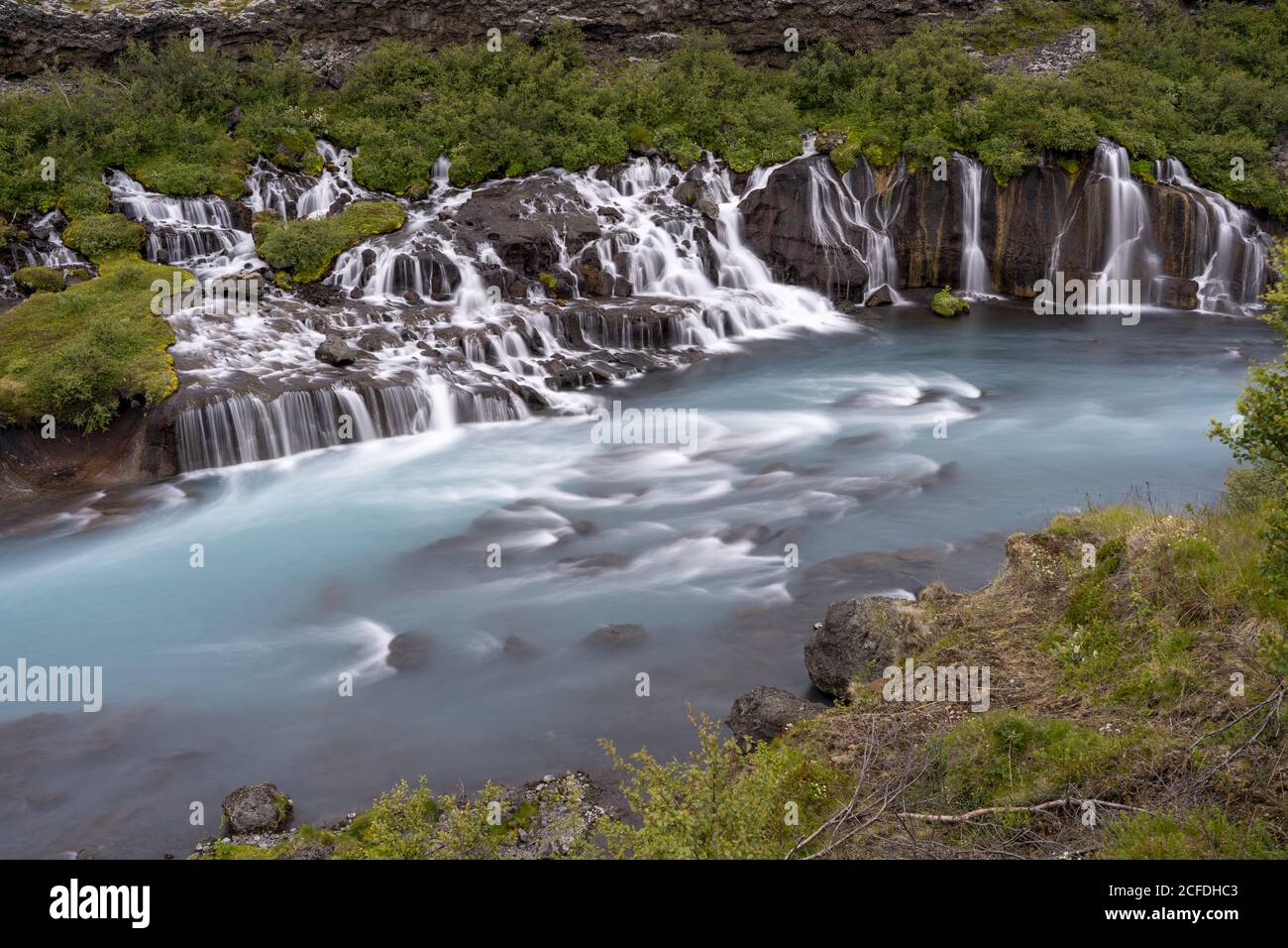 Hraunfossar waterfalls surrounded by greenery at daytime in Iceland ...