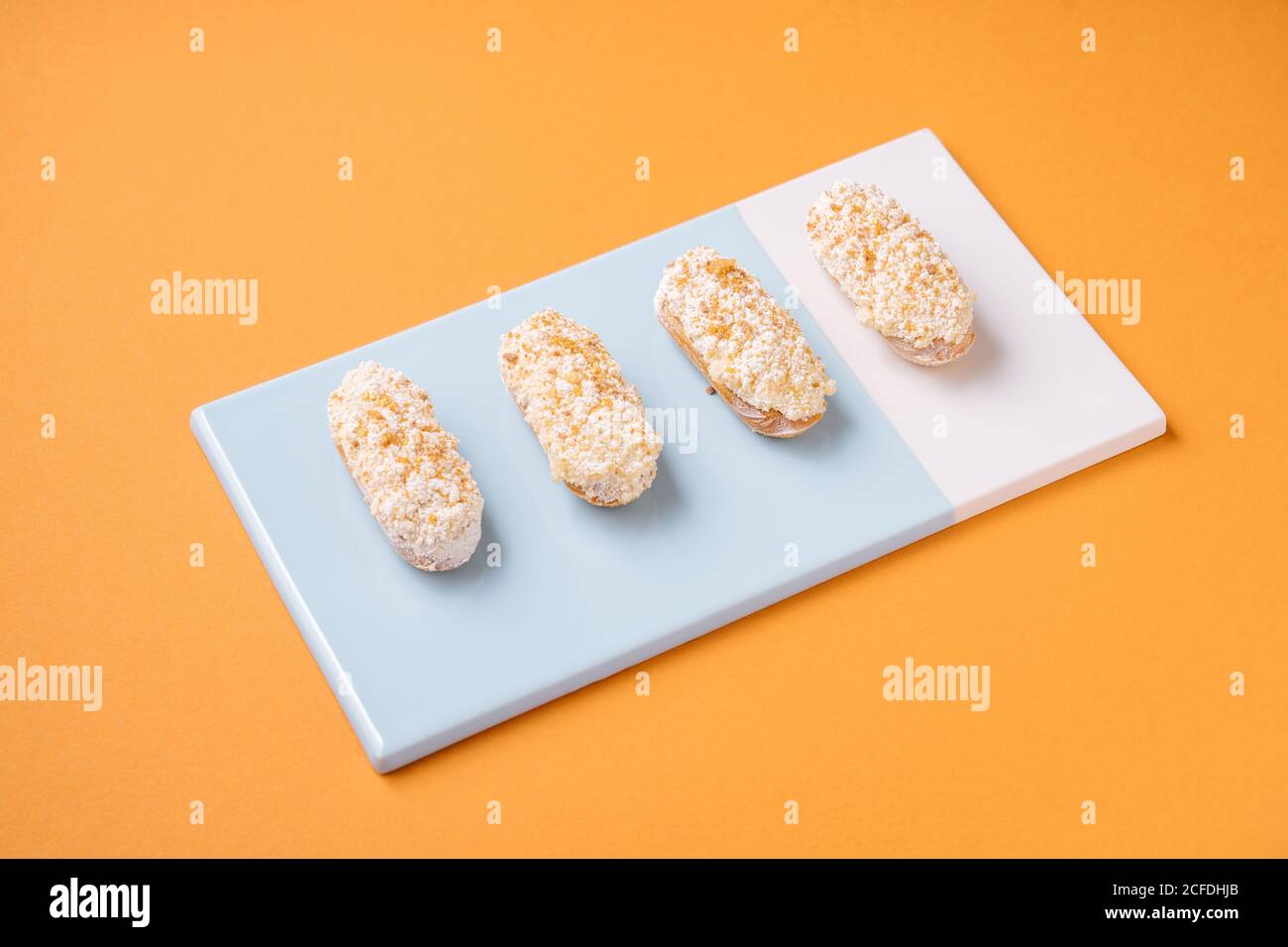 Sweet eclairs with white frosting Stock Photo - Alamy