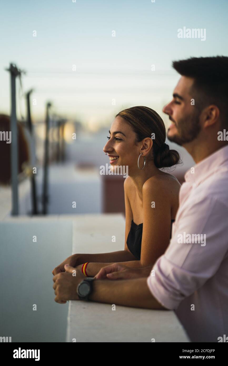 Happy couple standing in the balcony and having some romantic time ...