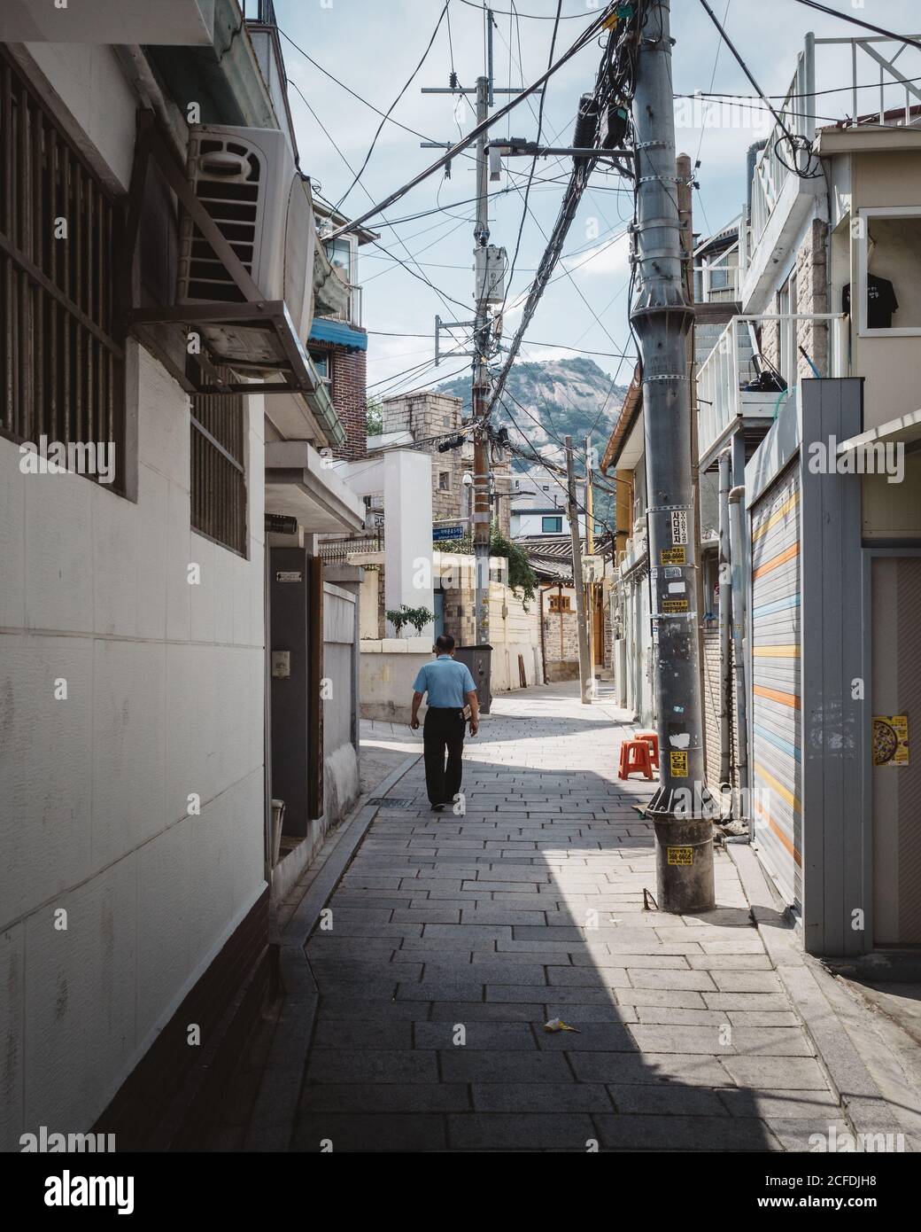 Seoul, South Korea - An old man walking through the alley in Seochon ...
