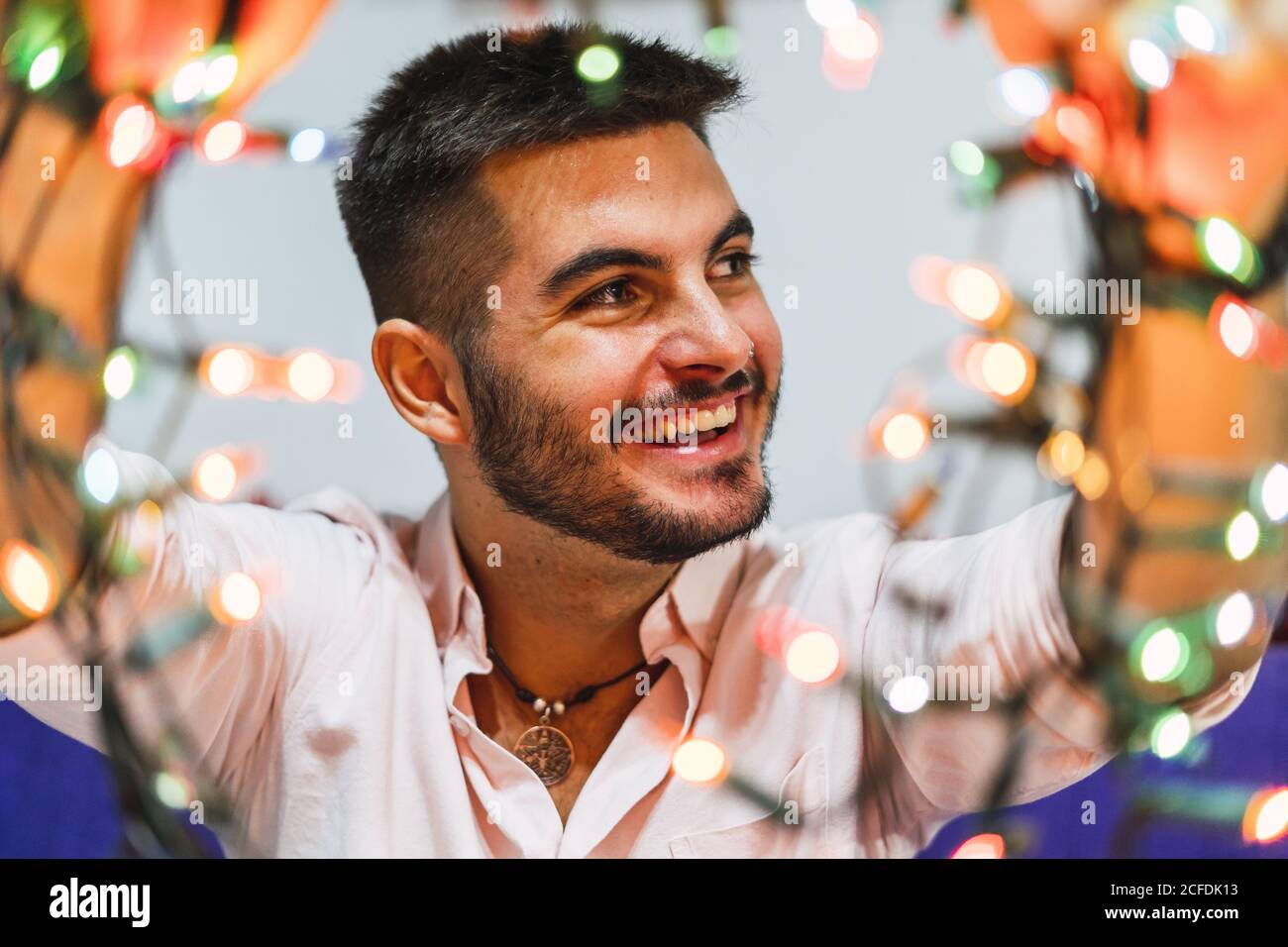 Shallow focus shot of a young male with Christmas lights Stock Photo ...