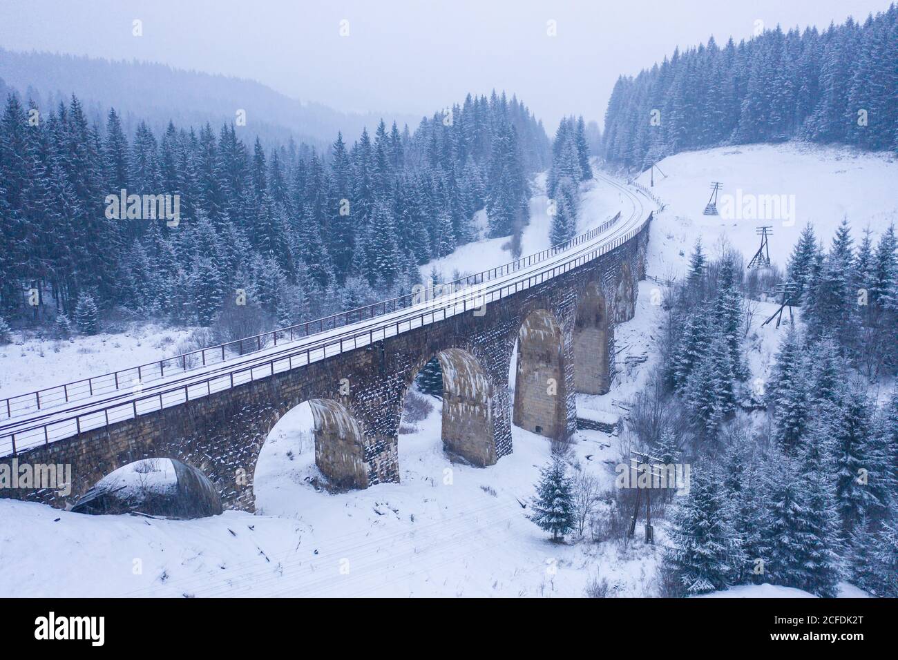 old snowy viaduct. old snow-covered railway bridge in Ukraine Stock ...
