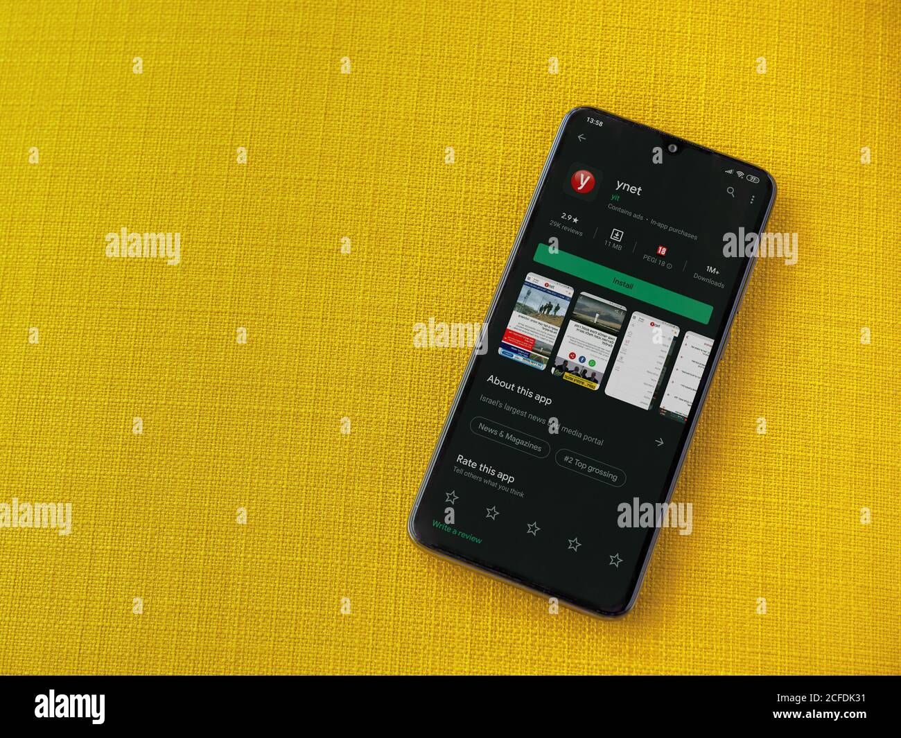 Lod, Israel - July 8, 2020: ynet app play store page on the display of a black mobile smartphone ...