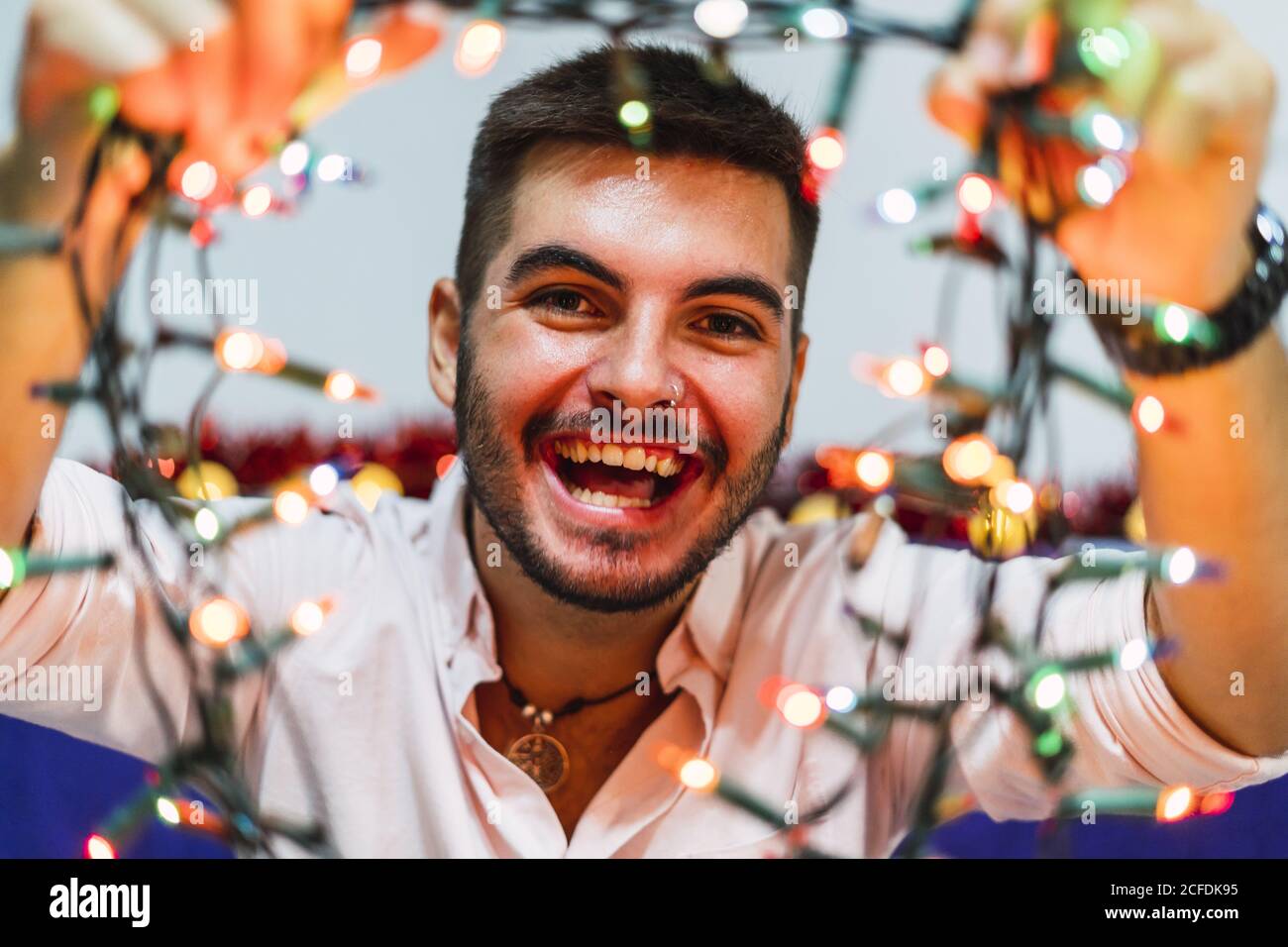 Shallow focus shot of a young male with Christmas lights Stock Photo ...