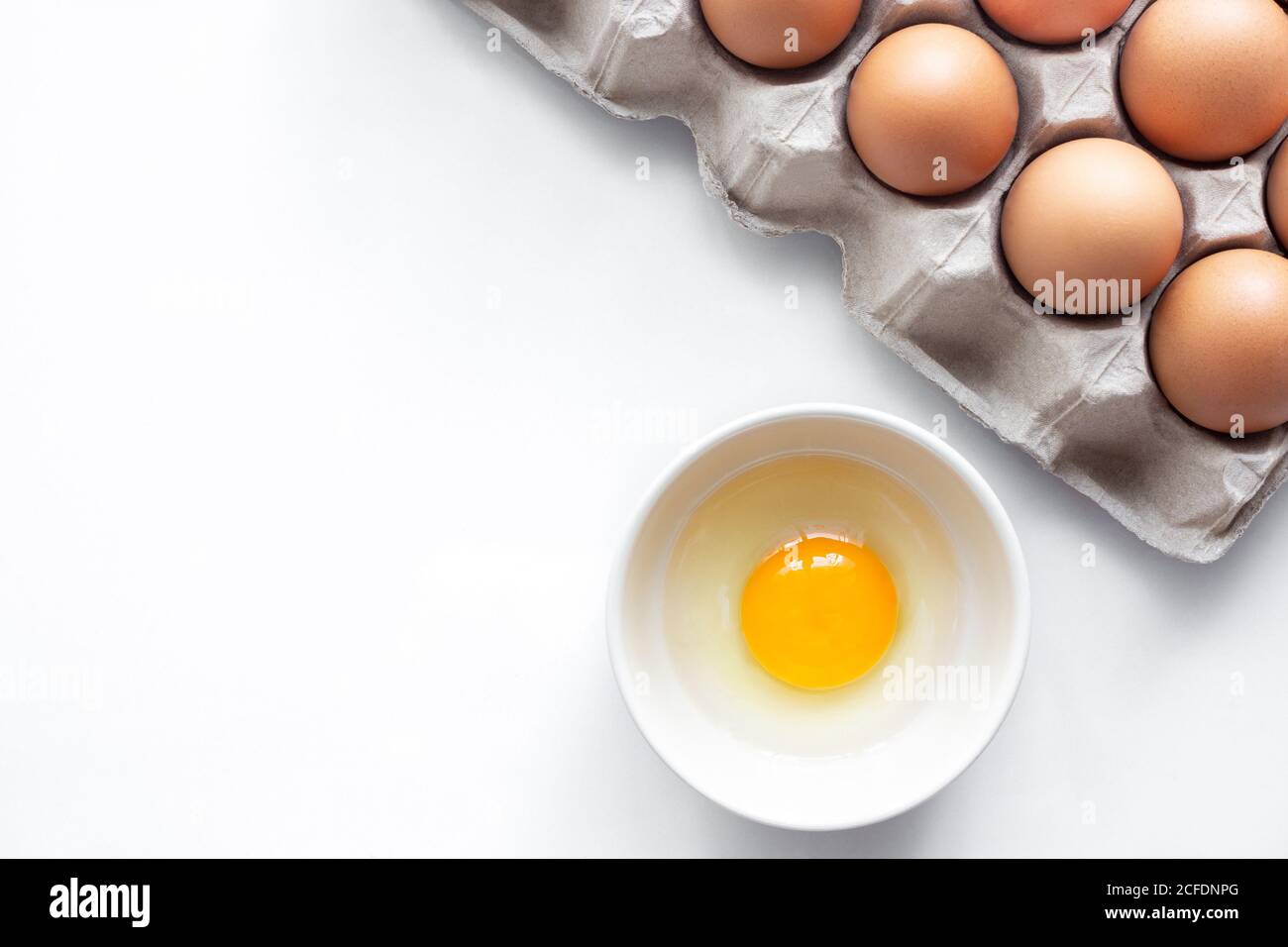 closeup of fresh chicken egg on egg box, panel, on white background ...