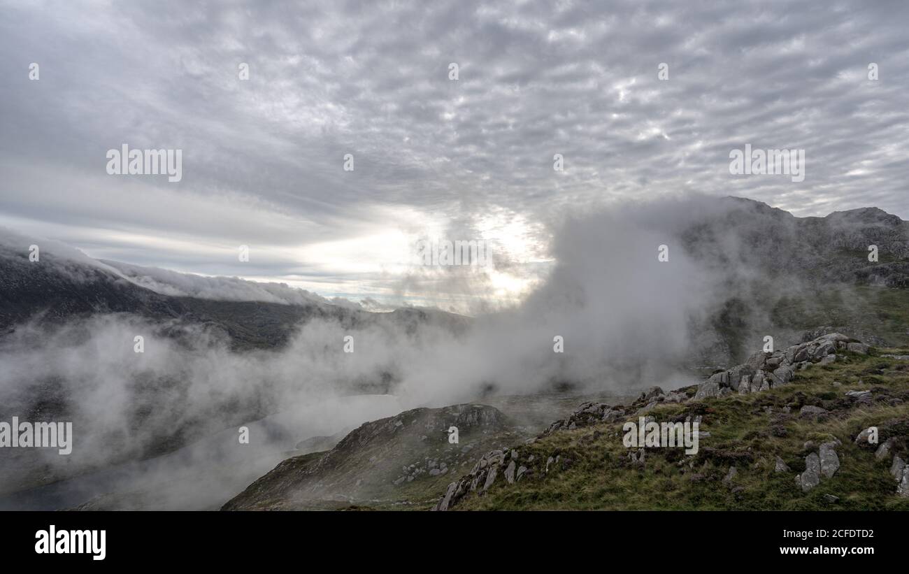 Cloud inversion mist rolling up a Welsh mountain in Snowdonia Stock ...