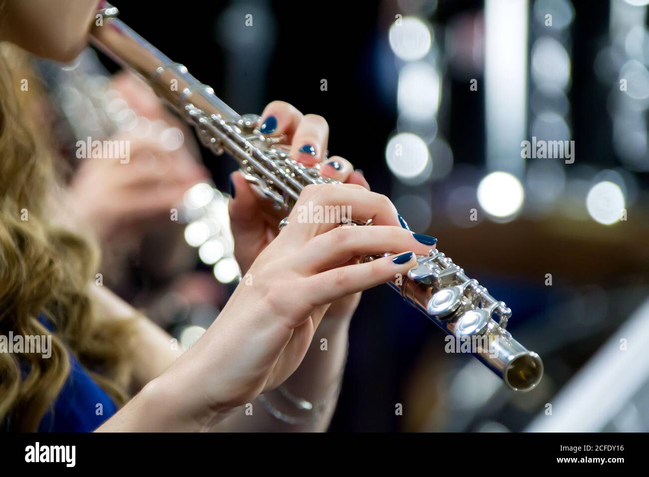 Hands holding a flute. Girl musician plays the flute Stock Photo - Alamy