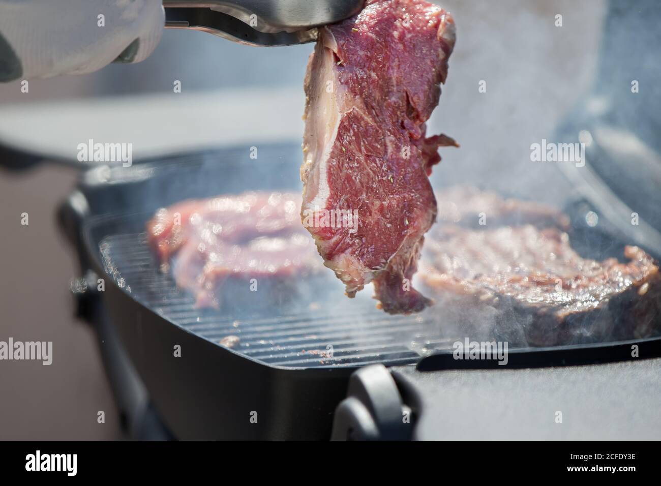 Grilled meat. A piece of meat in the smoke Stock Photo - Alamy