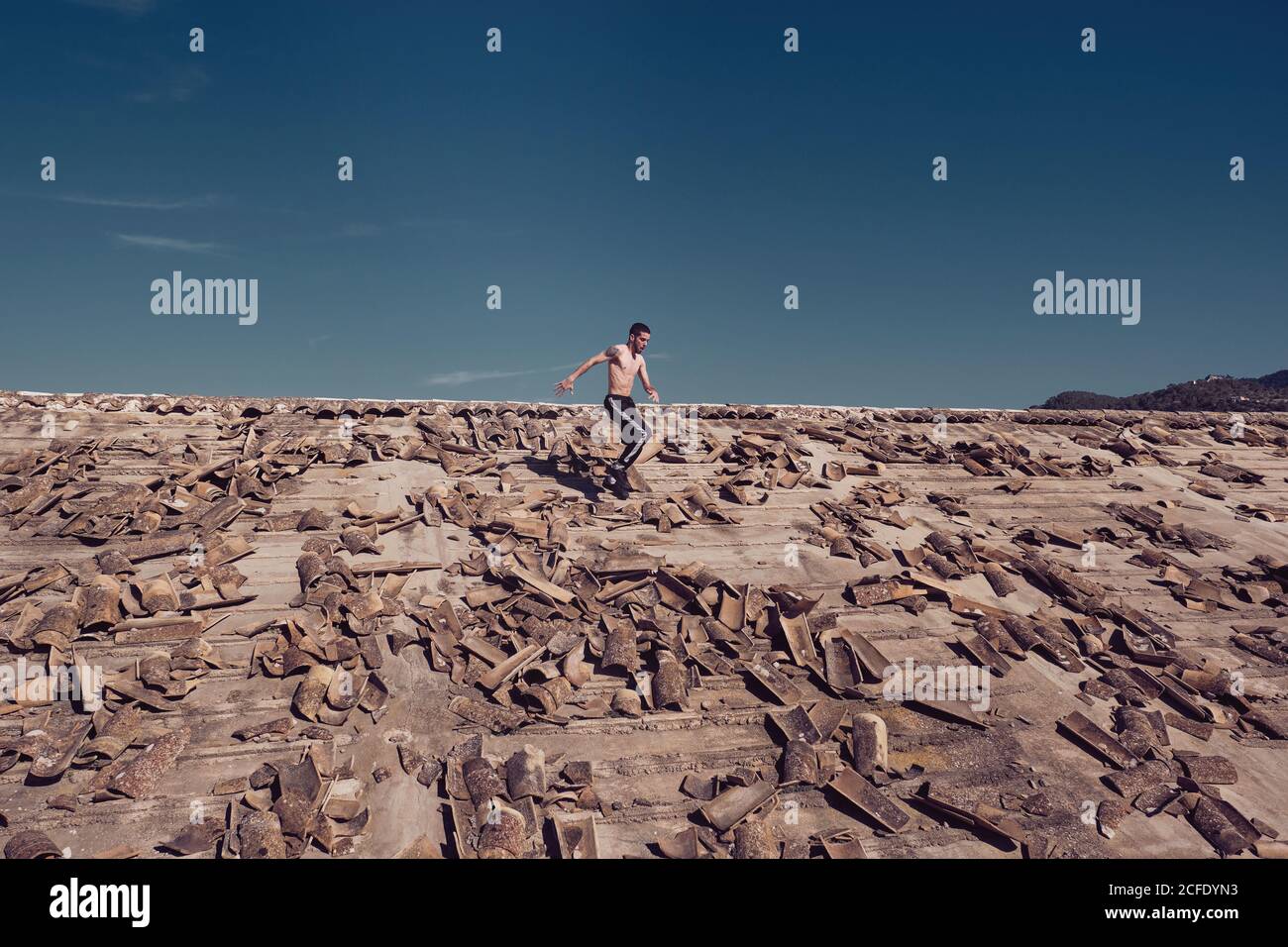 man running on roof Stock Photo - Alamy