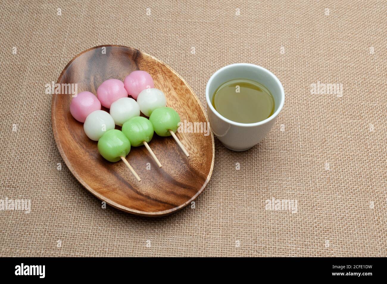 Japanese traditional sweet called Dango Mochi on wooden platter with ...