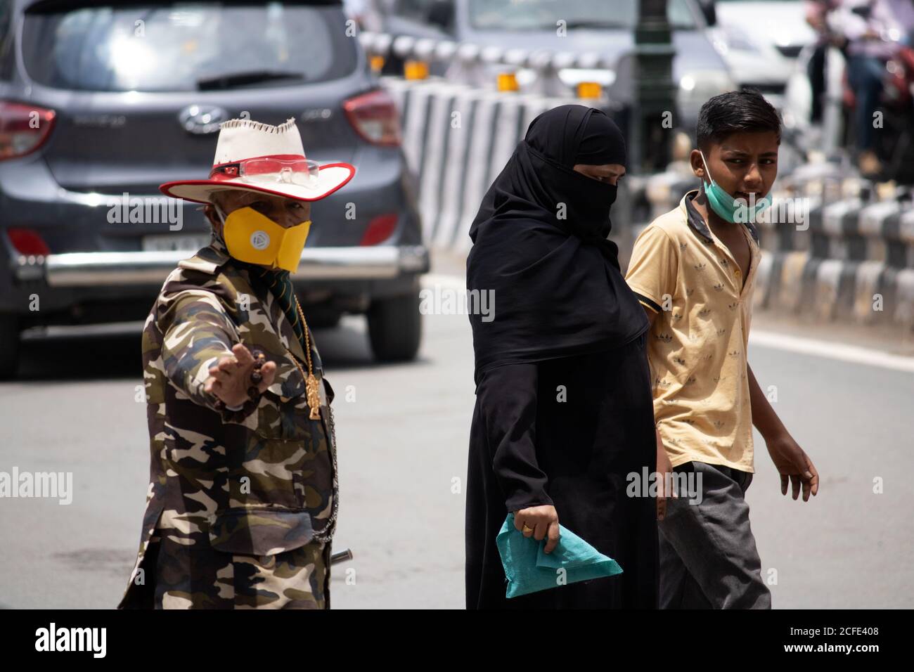 Police helping people crossing the road in a pandemic situation Stock ...