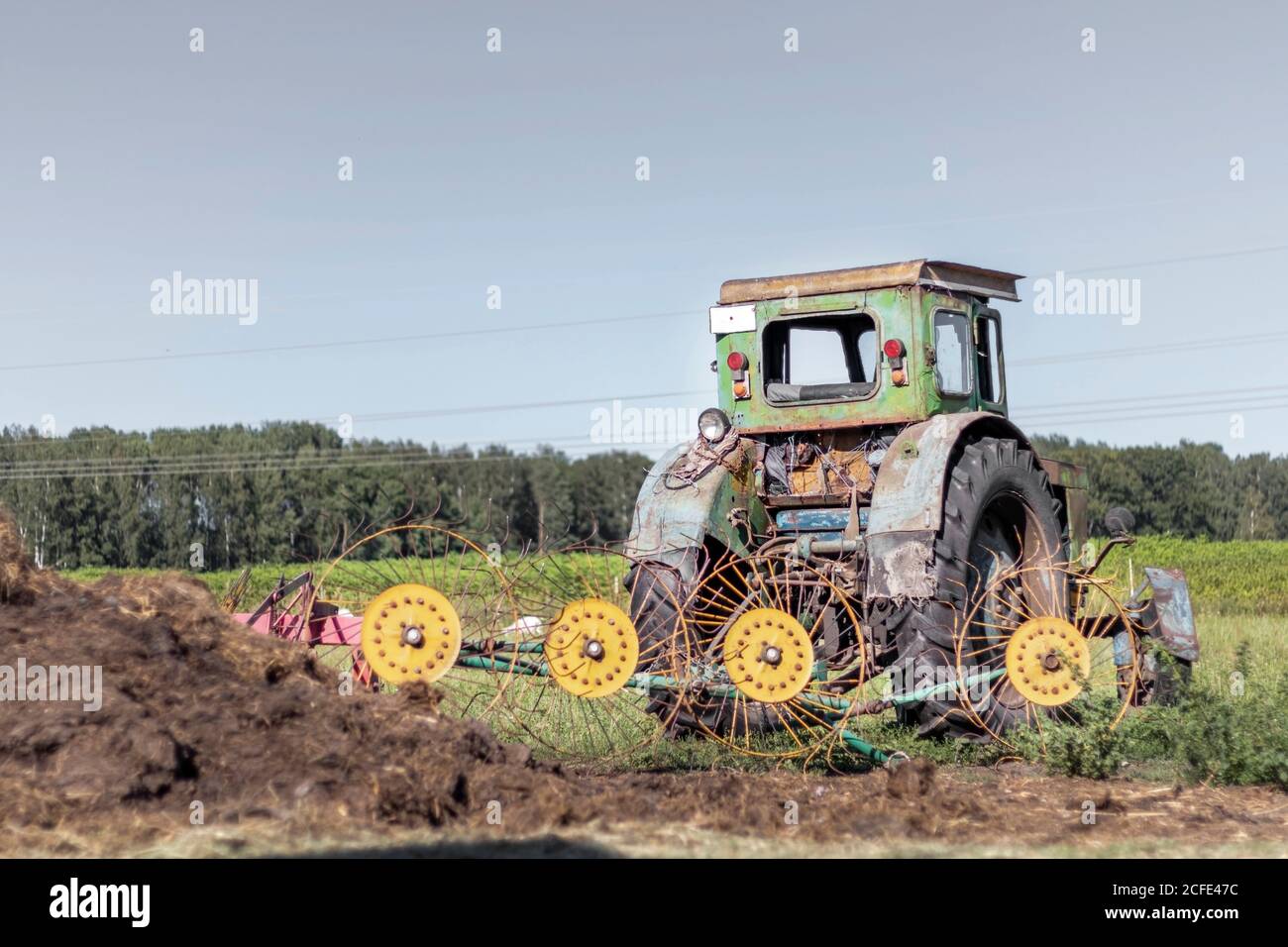 Very old tractor in the field with fertilizer ready to work in ...