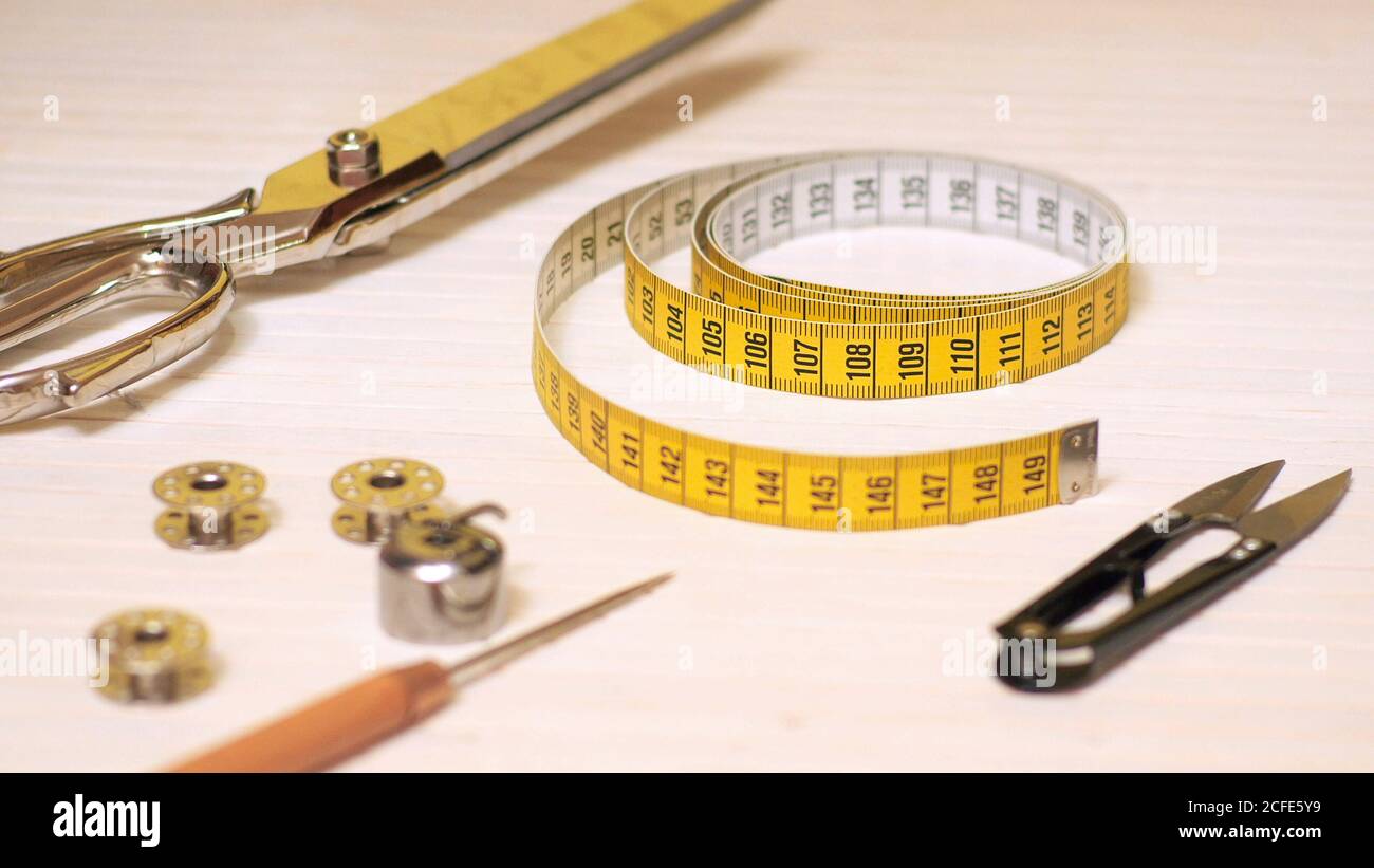 Tailor tools isolated on wooden background. Scissors, needle, Tailoring ...