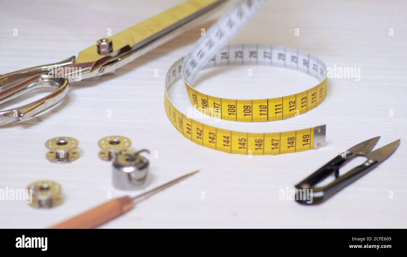 Tailor tools isolated on wooden background. Scissors, needle, Tailoring ...