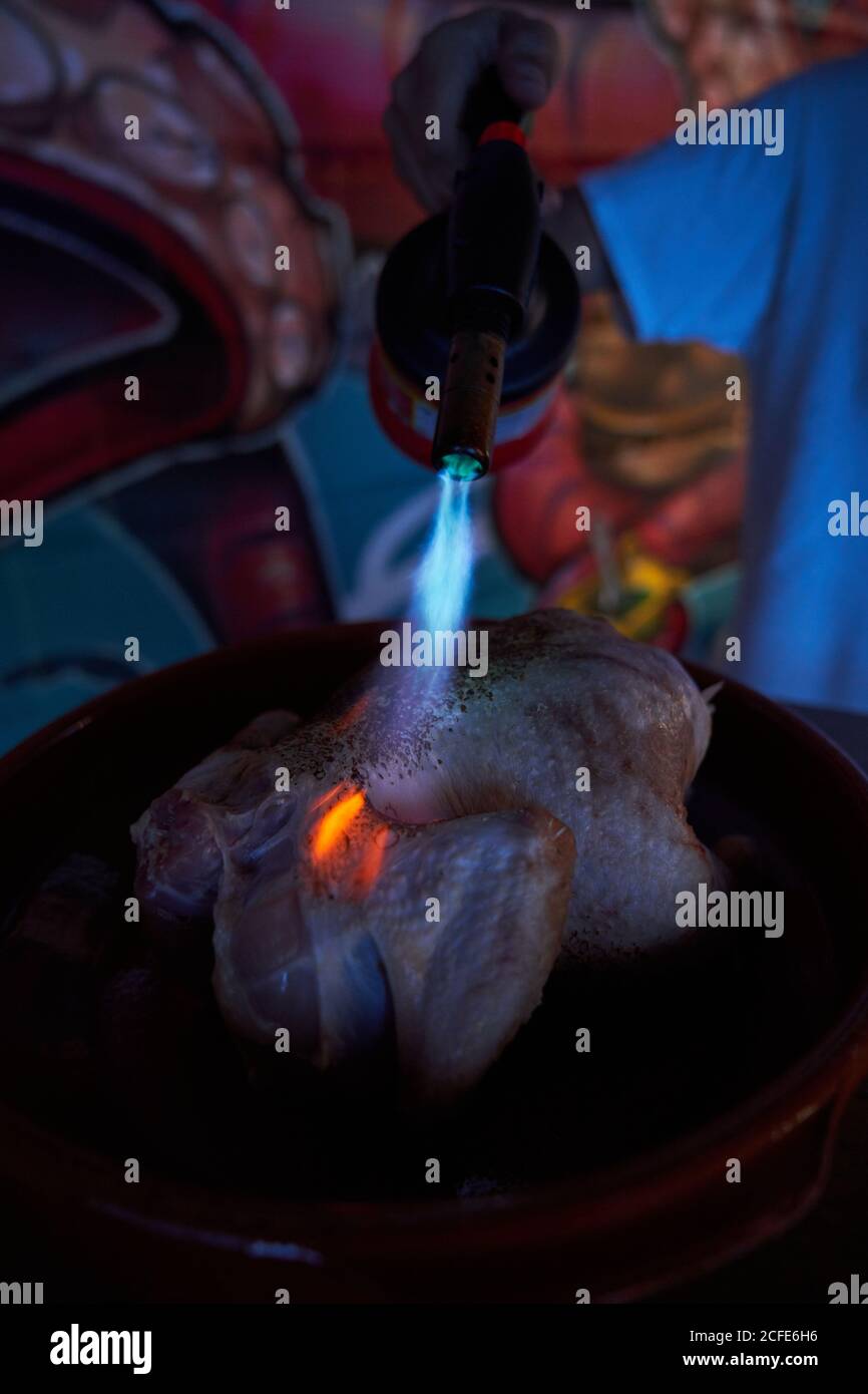 Whole fresh chicken during processing with flamethrower with bright gas ...