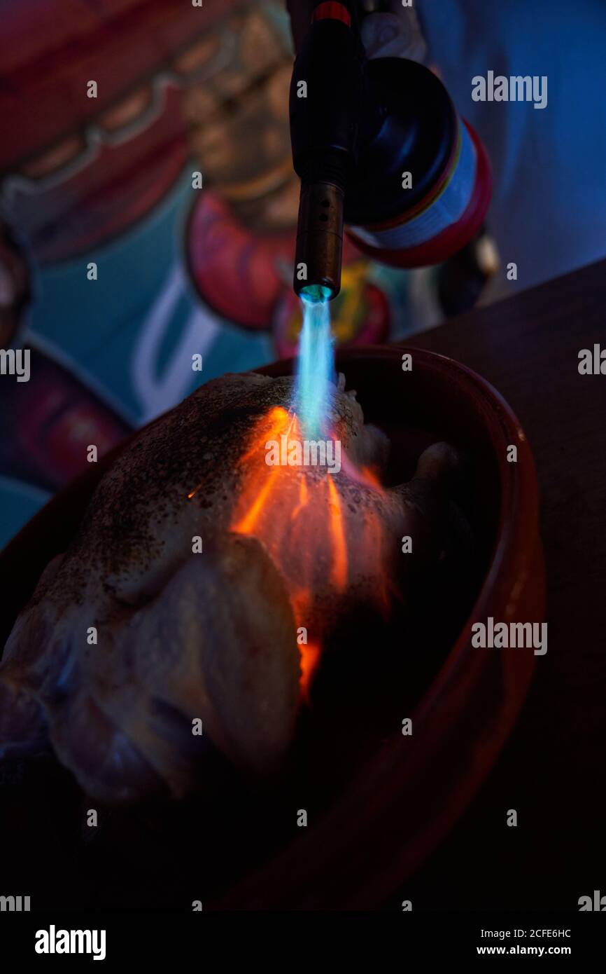 Whole fresh chicken during processing with flamethrower with bright gas ...