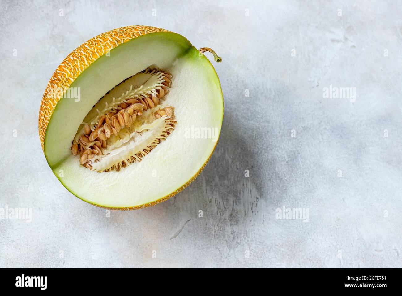 Fresh sweet melon on a light background, top view Stock Photo - Alamy