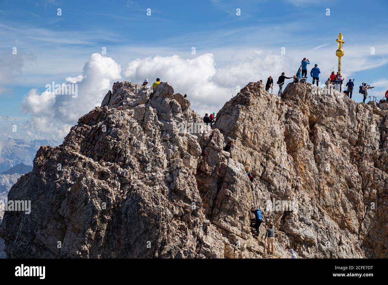Alps with the zugspitze and summit cross and alpinists hi-res stock ...