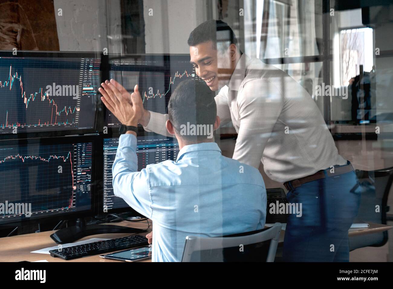 Stock Traiding. Traders sitting at office monitoring market achieving ...