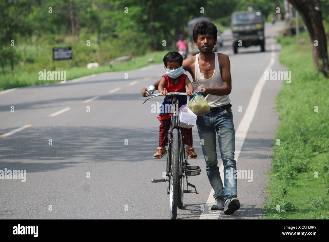 Dehradun, Uttarakhand/India- August 01 2020: Poor Indian with two ...