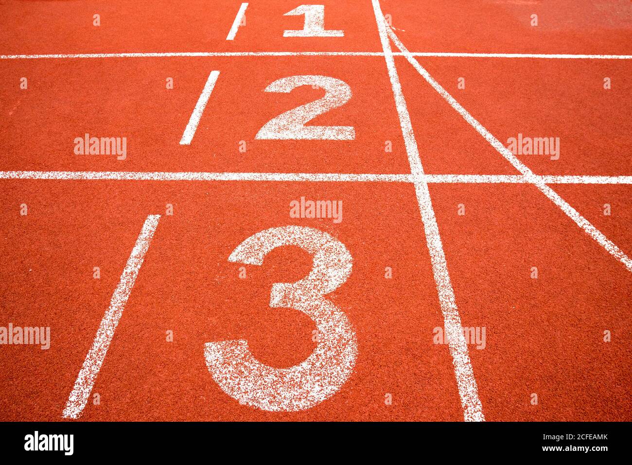 orange running track with white line and number Stock Photo - Alamy