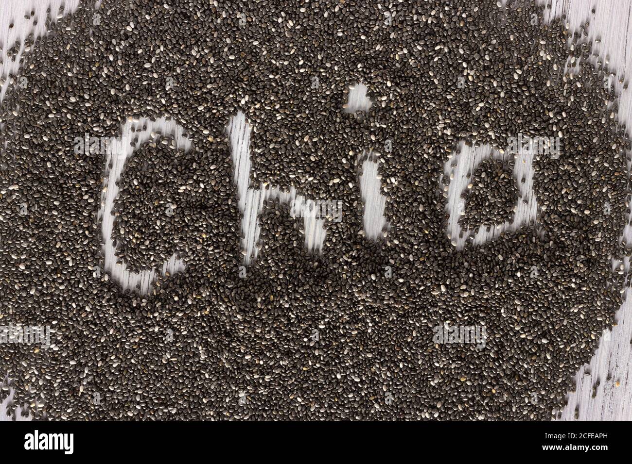 Word chia made from chia seeds on white wooden background. Healthy food ...