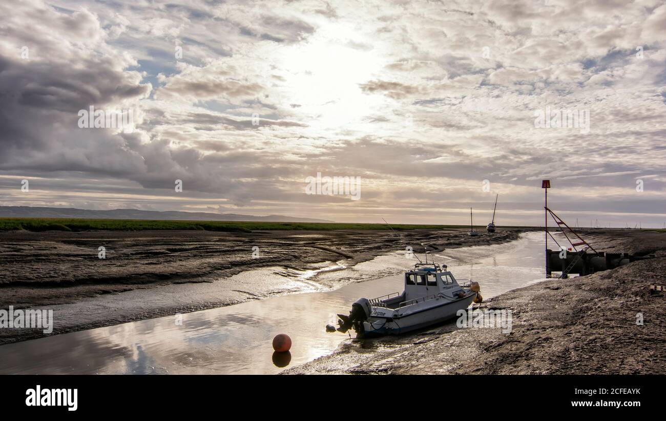 Beached boats waiting the tide on marshland at Lower Heswall boatyard ...