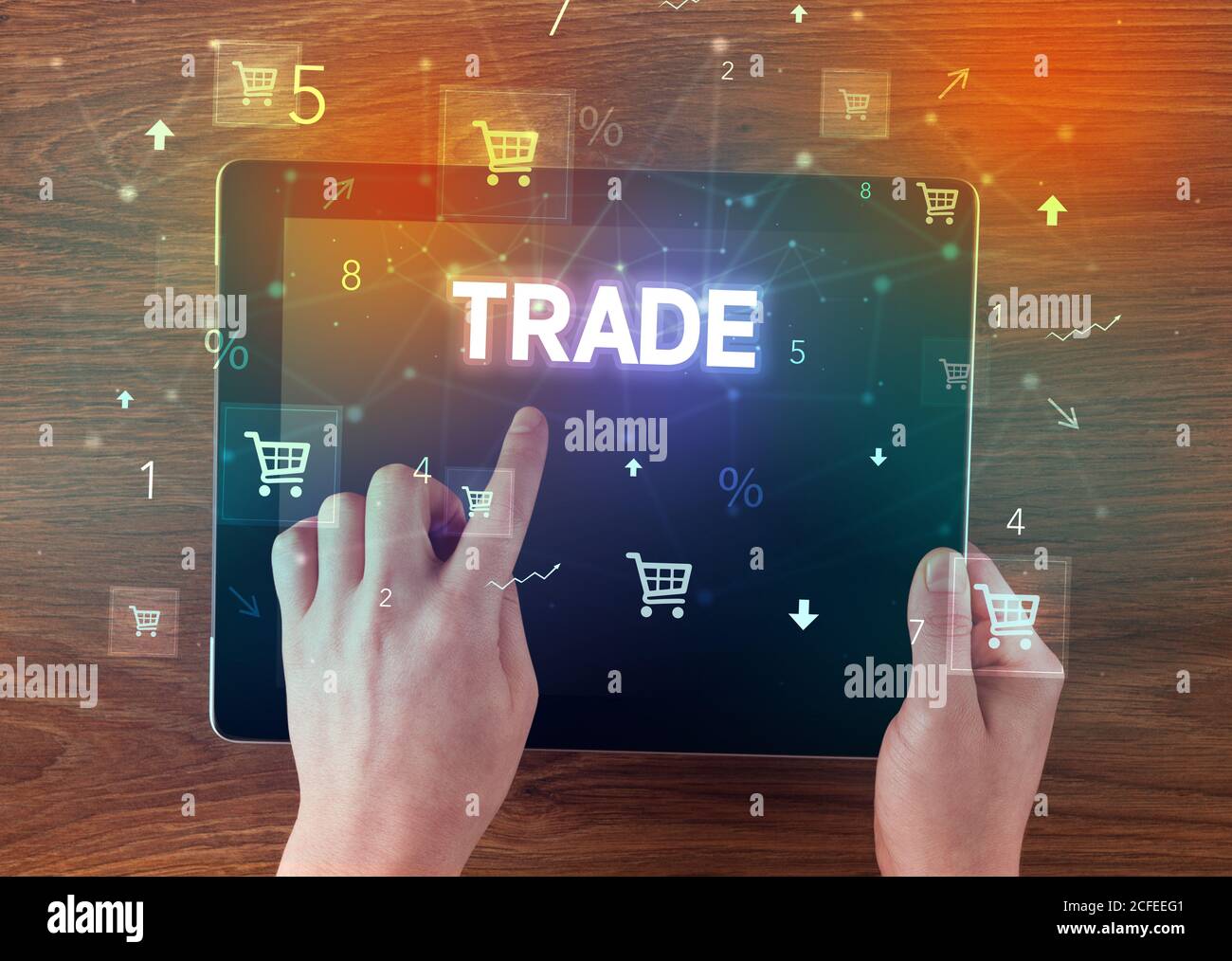 Close-up of a hand holding tablet with TRADE inscription, online ...