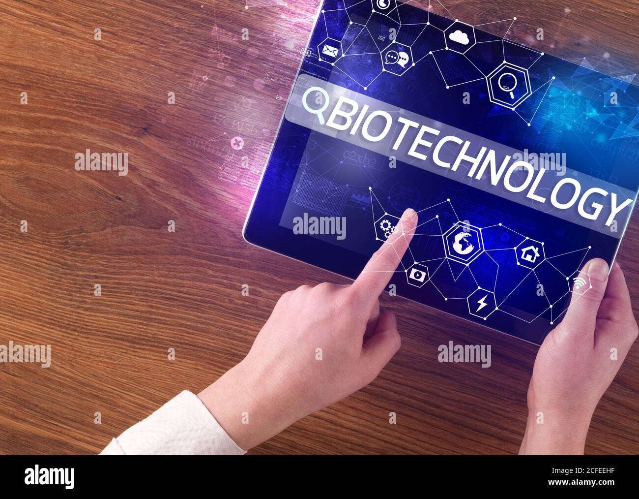 Close-up of a tablet searching BIOTECHNOLOGY inscription, hi-tech ...