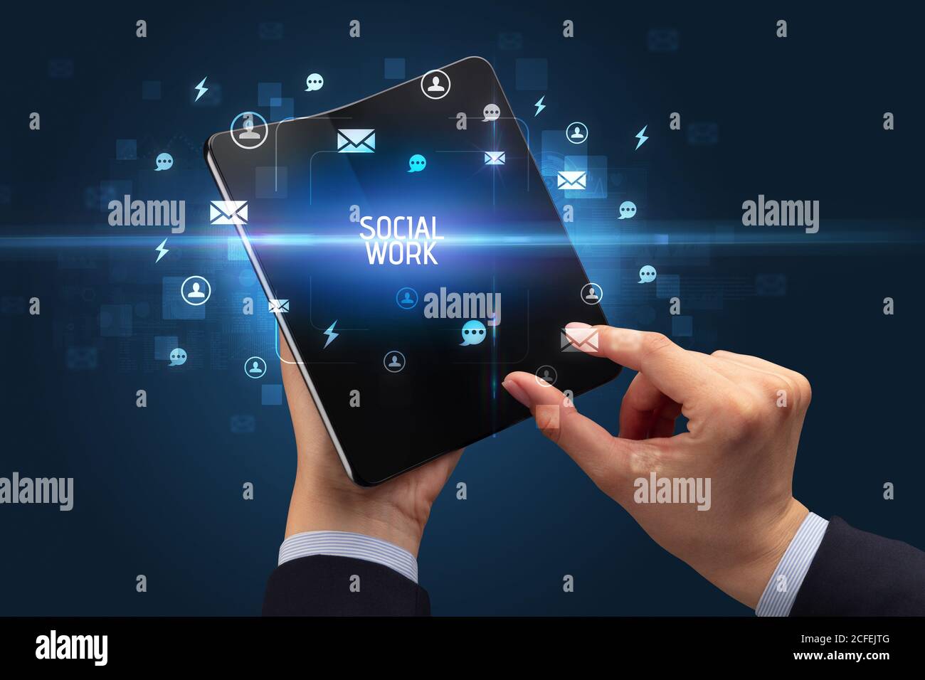 Businessman holding a foldable smartphone with SOCIAL WORK inscription ...
